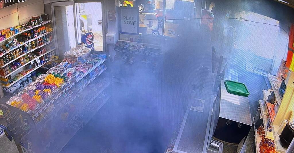 Masked football hooligans throw lit flare around Scottish forecourt ...